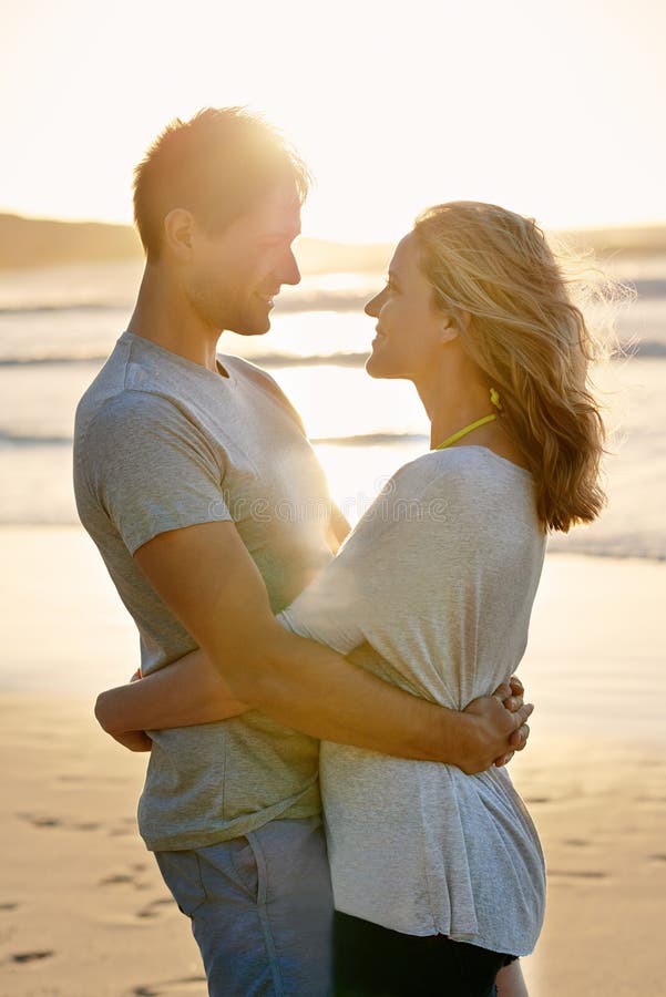 Lens Flare Sunset And Hug Of Couple At Beach Ocean And Sea With