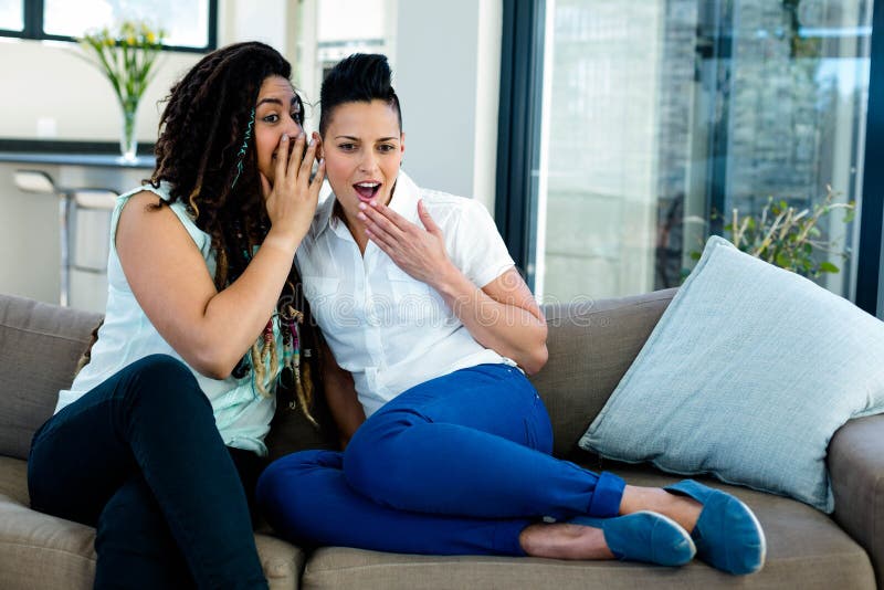 Lesbian Couple Whispering in Ear Stock Photo - Image of home, length ...