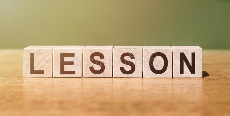 LESSONS Word Written on Wooden Blocks on Wooden Table. Concept for Your ...