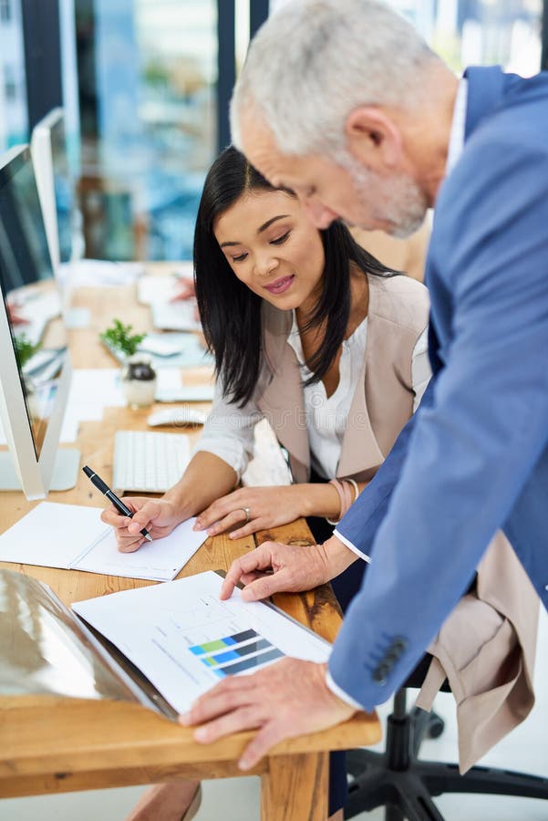 Let Me Help You. Two Businesspeople Working Together in the Office ...
