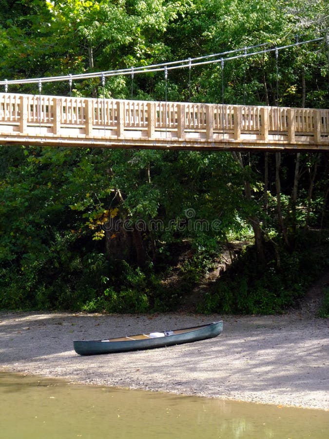 Canoe with Suspension Bridge Stock Image - Image of landscape, rock ...