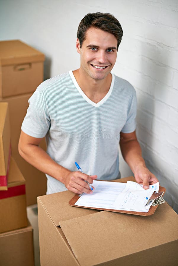 Let the Unpacking Begin. a Young Man Signing a Document for the ...