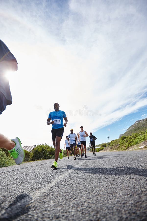 Let Us Run with Perseverance. a Group of Young Men Running a Marathon ...