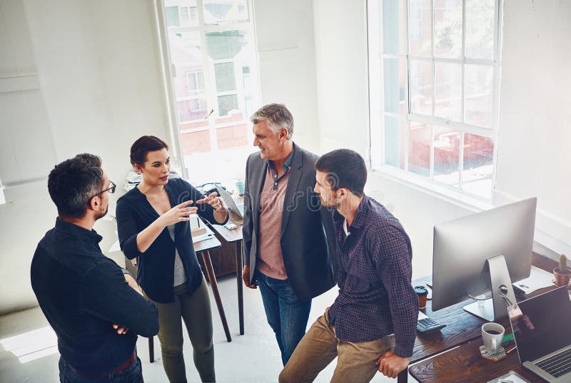 Lets Discuss the Challenge at Hand. a Group of Designers Having a ...