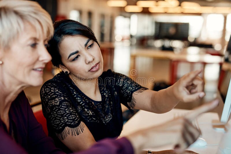 Lets Explore that. Two Businesswomen Using a Computer Together in a Modern Office. Stock Image ...