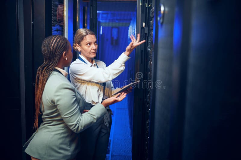 Lets Fix this Quickly. Two Technicians Using a Digital Tablet while ...