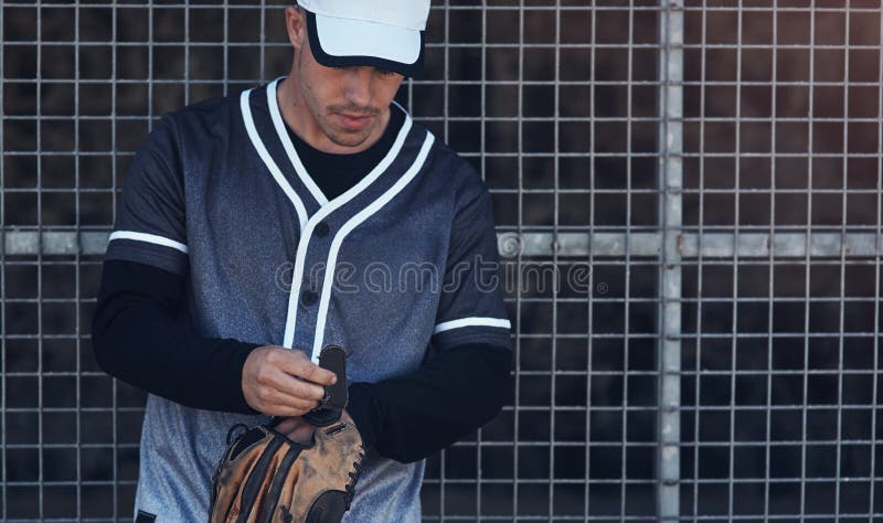 Lets Get the Ball Rolling. a Young Man Putting on His Mitt at a ...