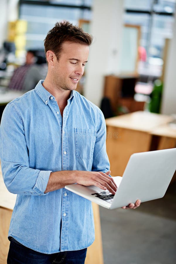 Lets Get Cracking on the Project. a Man Working on a Laptop in an ...