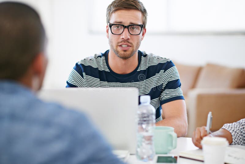 Lets Get Creative. a Group of Young Designers Working Around a Table ...