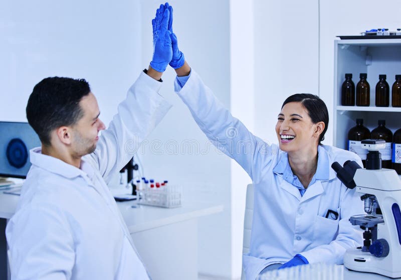 Lets Go. Two Young Scientists High Fiving while Working in Their Lab ...