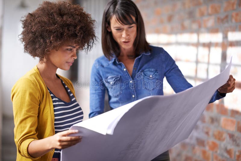 Lets Put this Plan To Use. Two Female Architects Discussing Blueprints ...