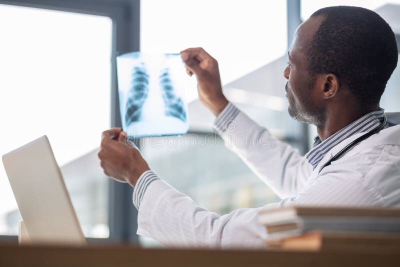 Serious Practitioner Sitting at His Workplace Stock Photo - Image of ...