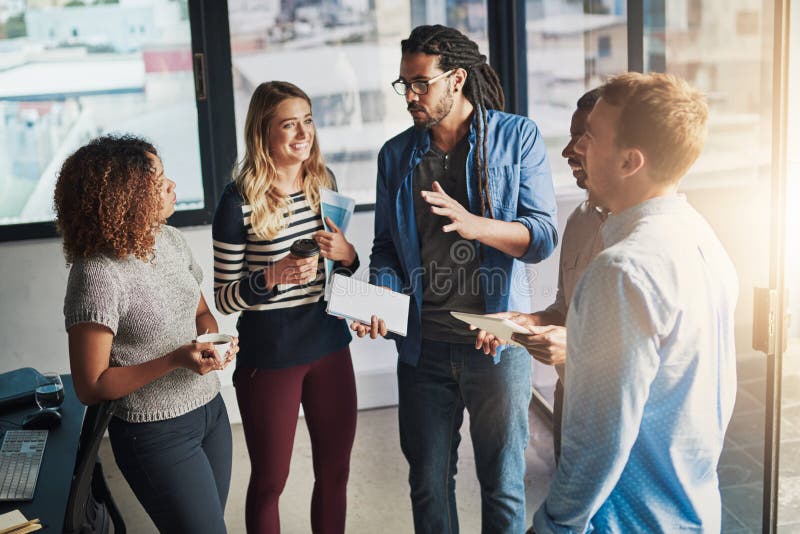 Lets Talk this through. High Angle Shot of a Group of Young Designers ...