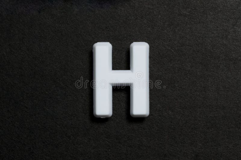 Pegboard Letter H on a Black Background Stock Photo - Image of sign ...