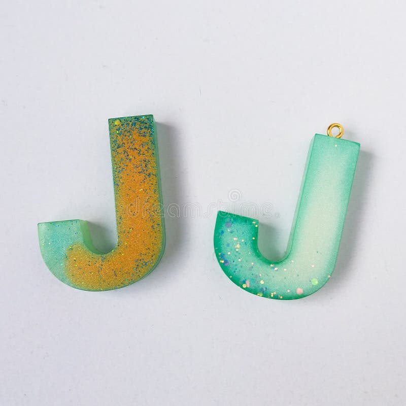 Letter J of the English Alphabet Made of Resin on a White Background ...