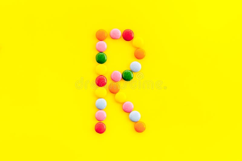 Letter R - Alphabet Made with Sweets on Yellow from Above Stock Image ...
