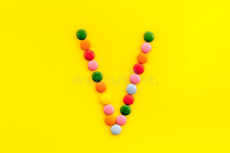Letter V - Alphabet Made with Sweets on Yellow from Above Stock Photo ...