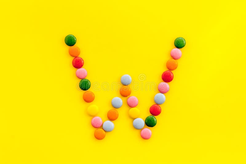 Letter W - Alphabet Made with Sweets on Yellow from Above Stock Photo ...