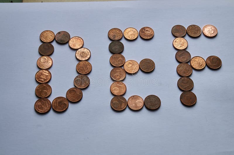 Letters D E F of Copper Coins Insulated on a White Sheet of Paper ...