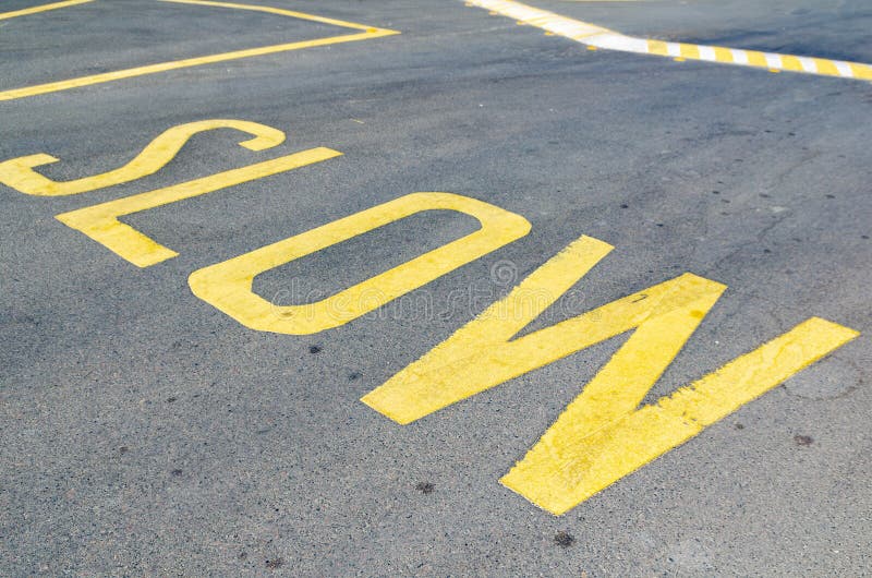 Letters Slow on Road Surface Stock Image - Image of yellow, everyday ...