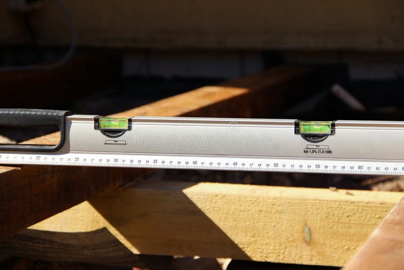Level Check of Wooden Beam. Building Level in Use Stock Photo - Image ...