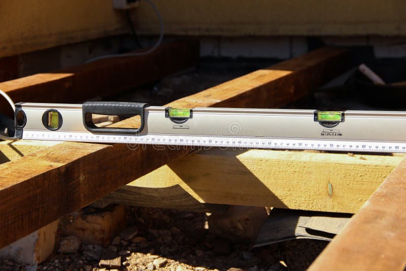 Level Check of Wooden Beam. Building Level in Use Stock Photo - Image ...