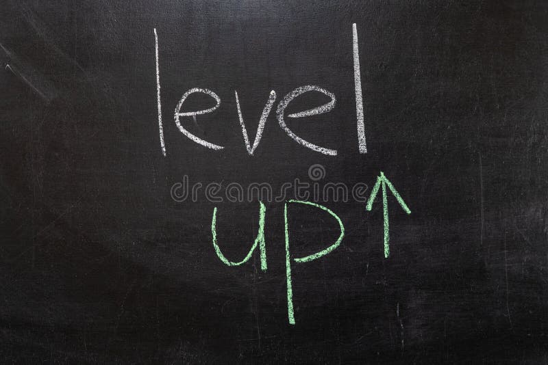 LEVEL UP Text on a Chalkboard, the Concept of Raising the Level Stock ...