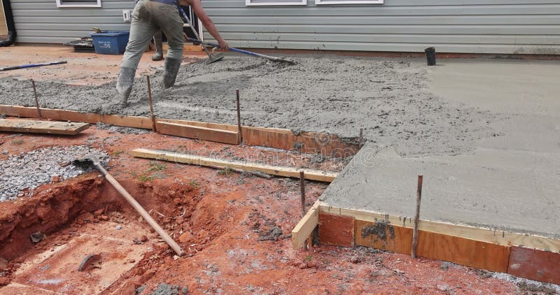 Leveling Concrete for Foundation by Mason at a Construction Site Stock ...
