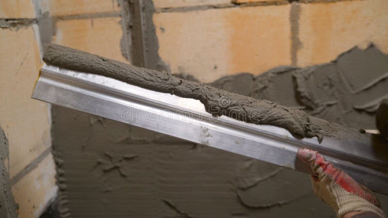 View of Builder Hands Plastering on Block Wall. Worker Leveling the ...