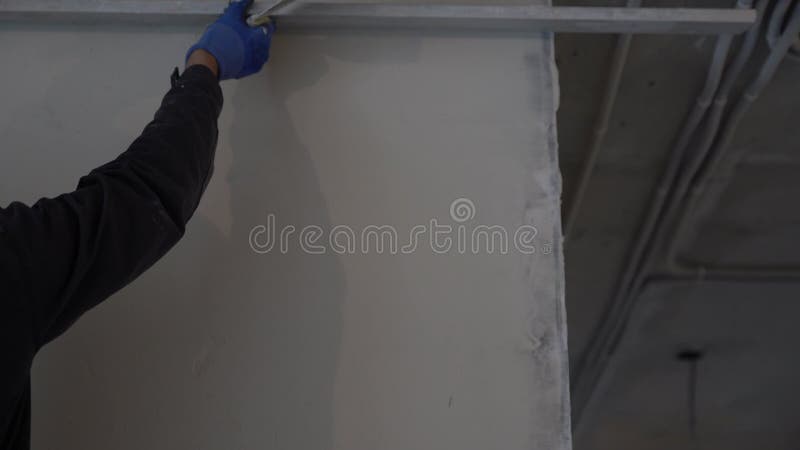 Leveling the Plaster Layer on the Wall with a Metal Spatula. the ...