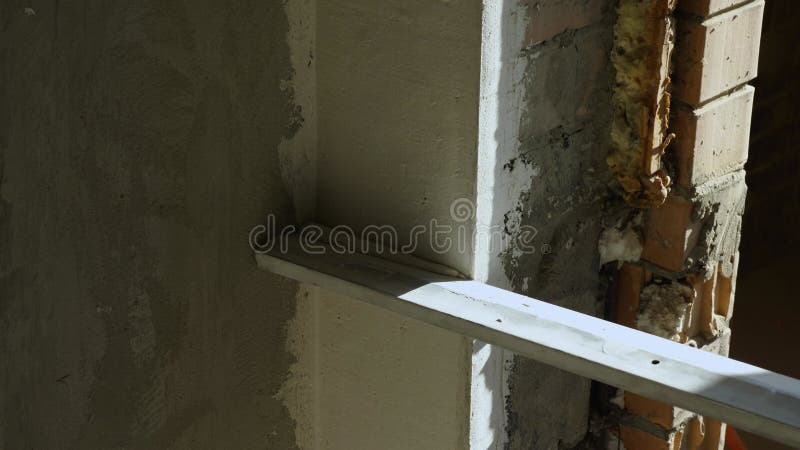 Leveling Plaster on the Wall with a Special Construction Tool. the ...