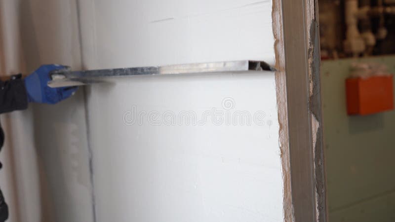 Leveling the Plaster on the Wall Using a Metal Rule. the Builder ...