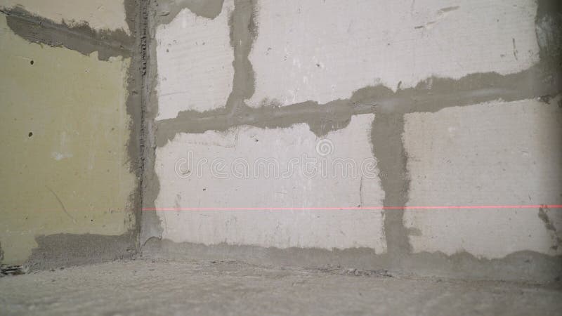 Leveling the Wall with a Laser Level. Lighted Laser Level. Display ...