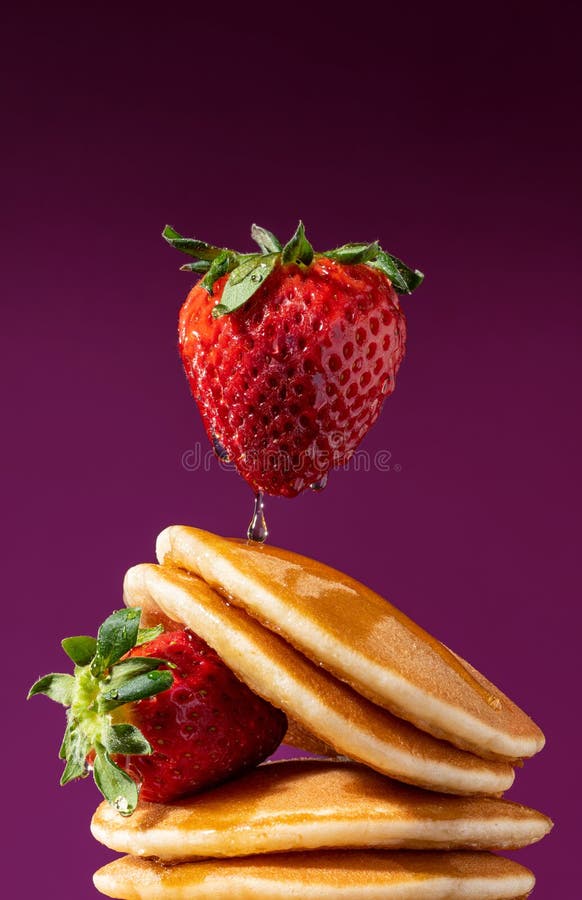 Levitating Strawberry Over a Stack of Pancakes Drizzled with Honey ...