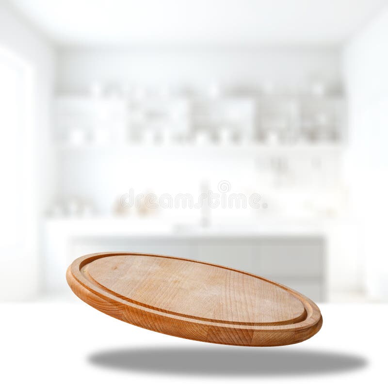 Levitating Wooden Cutting Board Above White Table with Blurred Bright ...