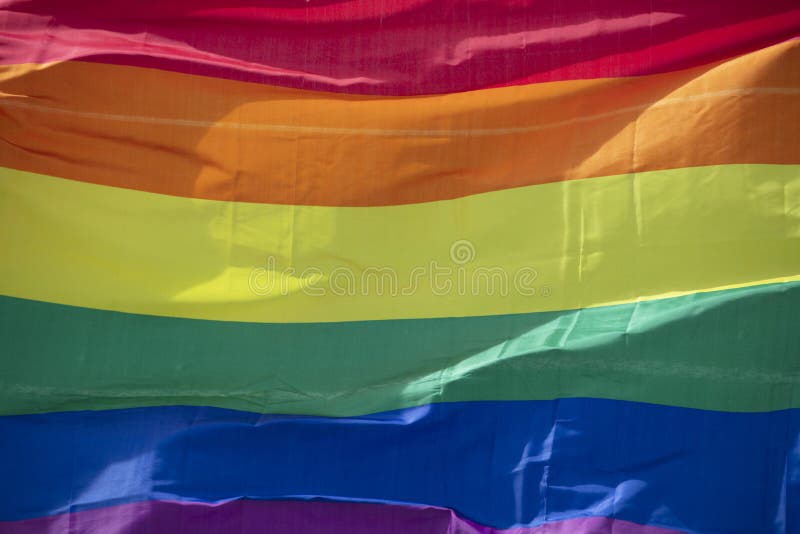 A Lgbt Gay Pride Rainbow Flag Being Waved At A Pride Community