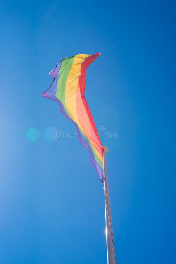 LGBT Pride Flag Waving in the Blue Sky Stock Image - Image of people ...