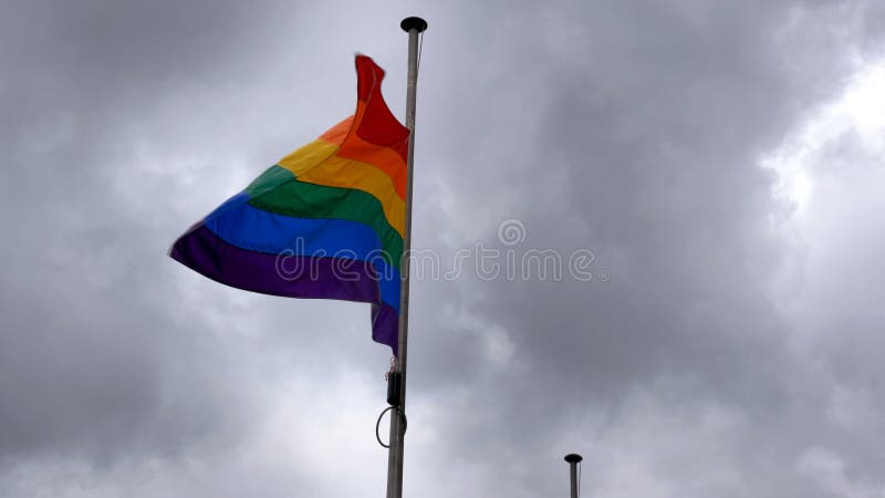 Lgbt Rainbow Pride Flag Waving At Wind On Cloudy British Sky Background