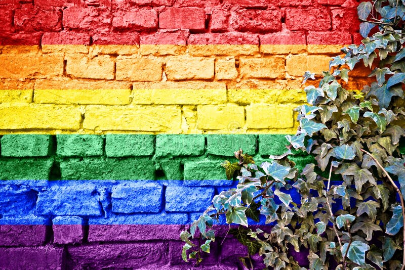 Lgbtq Pride Rainbow Grunge Flag On Brick Wall With Ivy Plant Stock