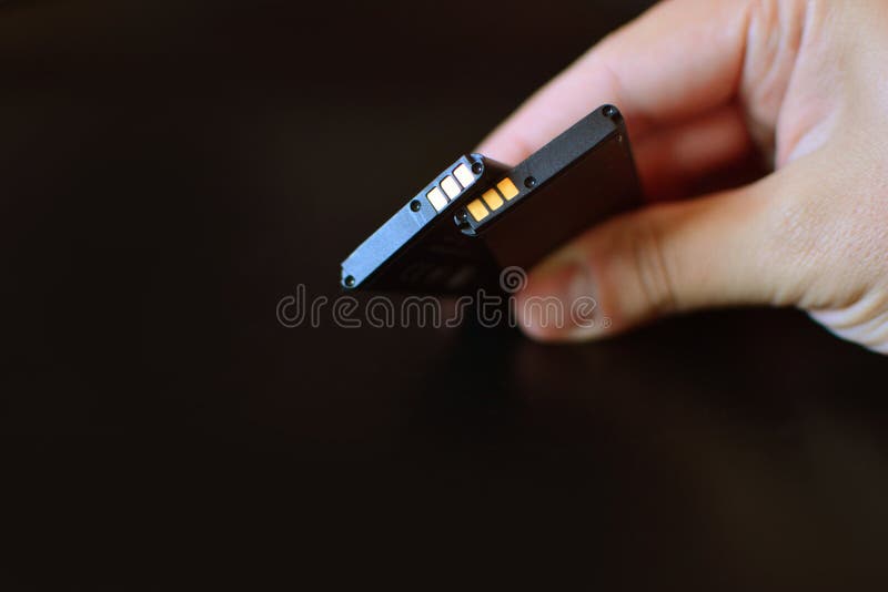 Lithium battery in a hand stock image. Image of electro - 134765165