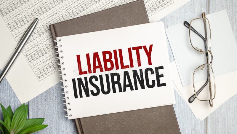LIABILITY INSURANCE Words on Notepad and Pen with Charts on Blue ...