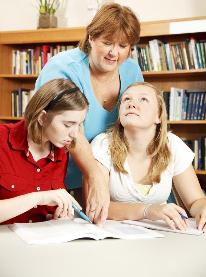 Librarian Assists Students stock photo. Image of cute - 17030446