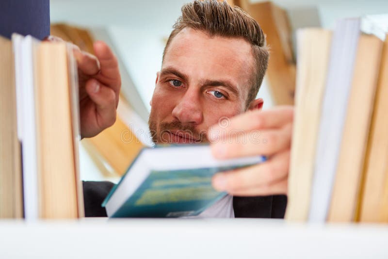 Librarian Looks for Book on the Shelf of the Library Stock Image ...