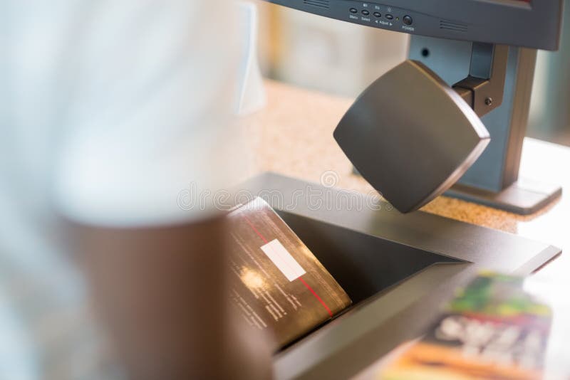 Librarian Scanning Books at Counter in Library Stock Image - Image of ...