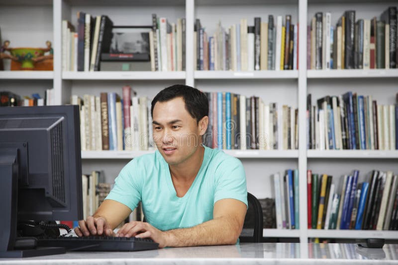 Librarian Using Computer in Library Stock Image - Image of computer ...