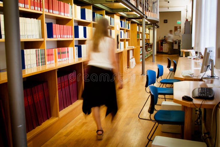 Librarian Walking Down a Library Aisle Stock Photo - Image of database ...