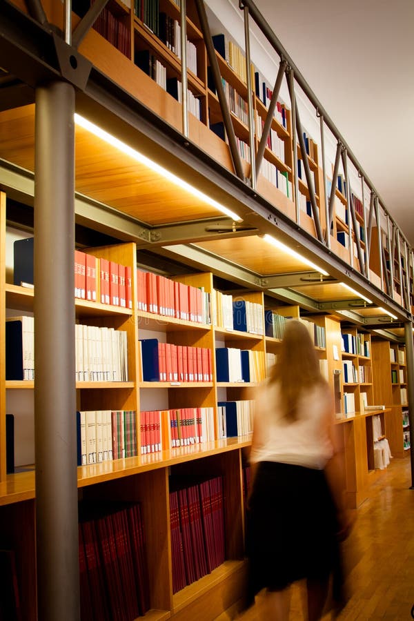Librarian Walking Down a Library Aisle Stock Photo - Image of database ...
