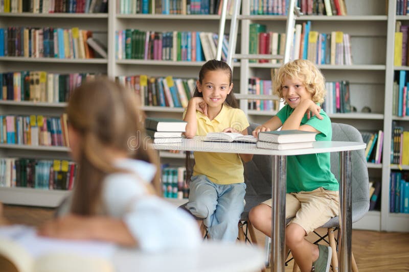 Classmates Reading Together in a School Library Stock Image - Image of ...