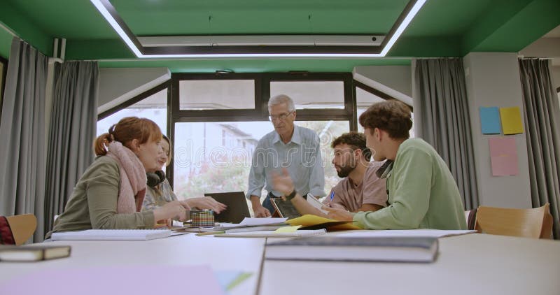 College Students Collaborate on a Project, Receiving Guidance from ...