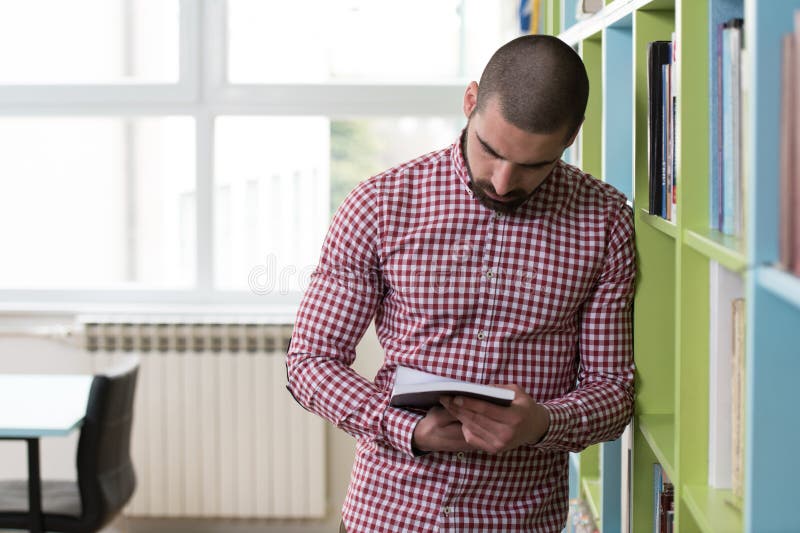Student Reading from Book in a Library Stock Photo - Image of college ...